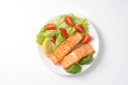 A plate of food with salmon and salad. - Levana Cooks